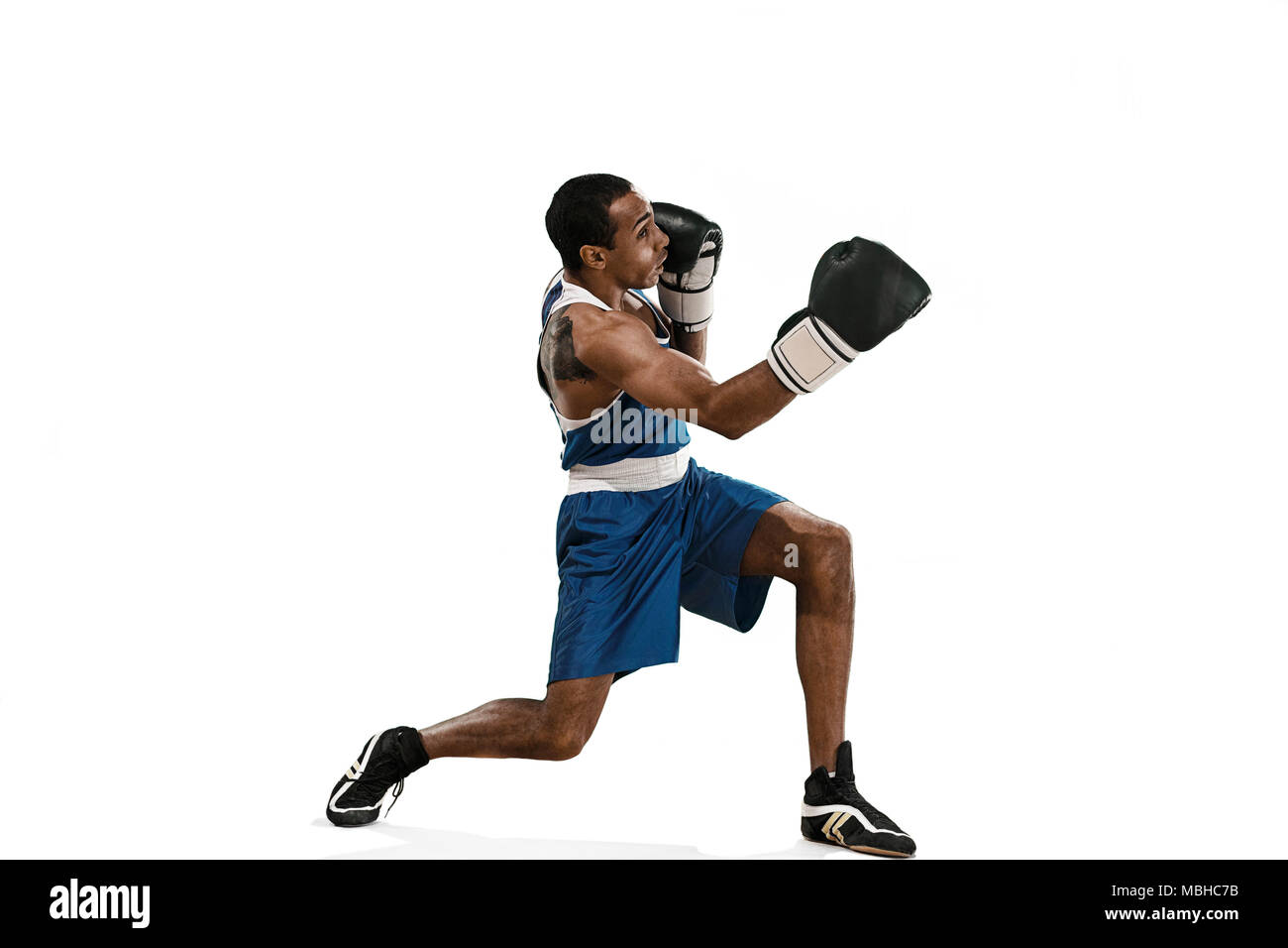 Sporty man during boxing exercise making hit. Photo of boxer on white ...