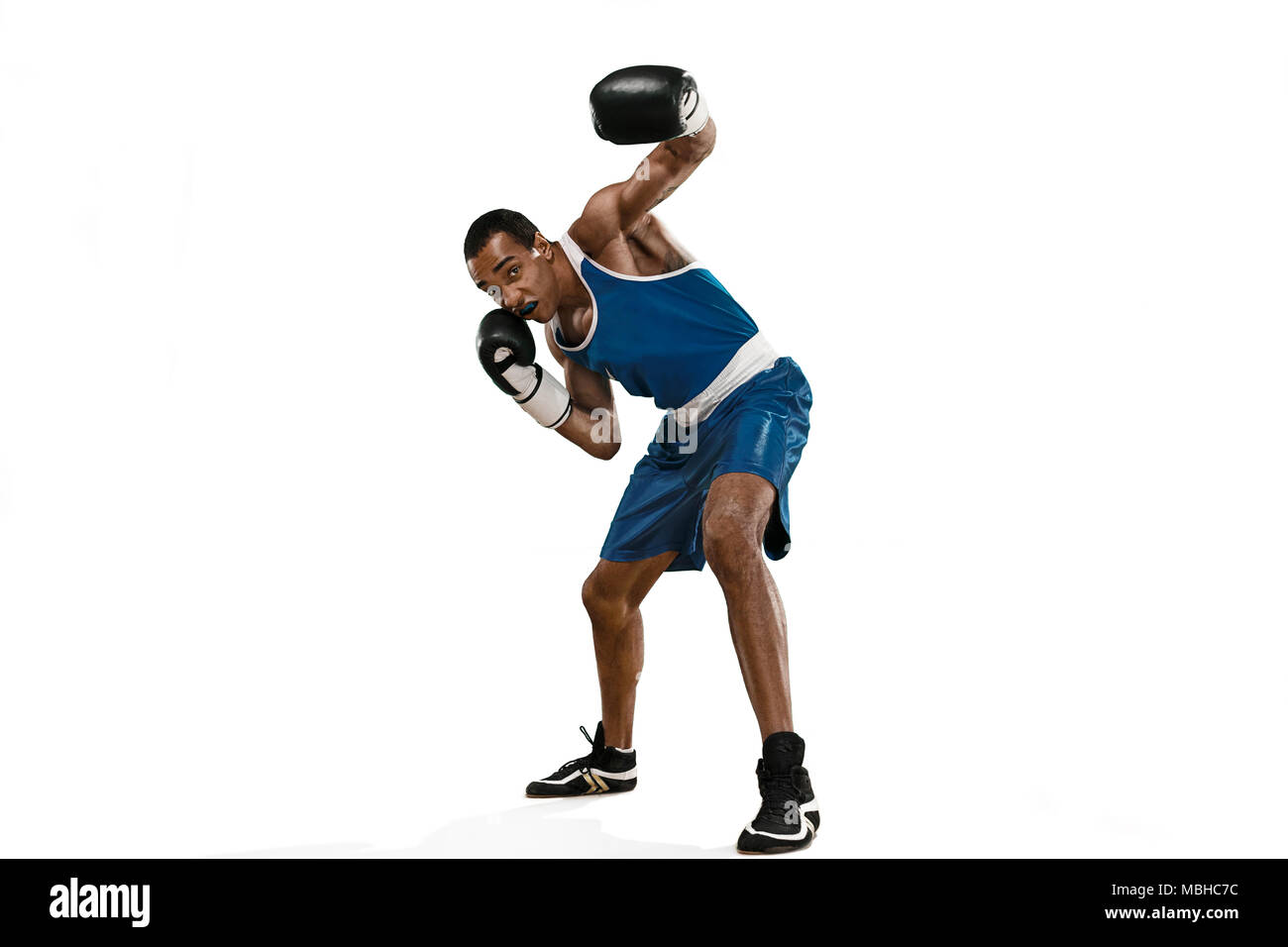 Sporty man during boxing exercise making hit. Photo of boxer on white ...
