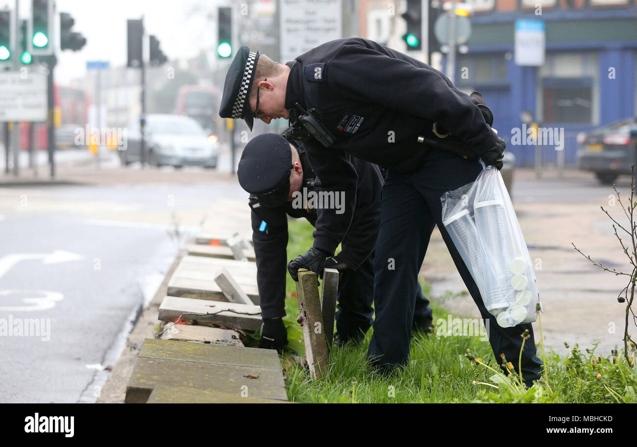 Police officers conduct a weapons sweep in Thornton Heath, south London ...