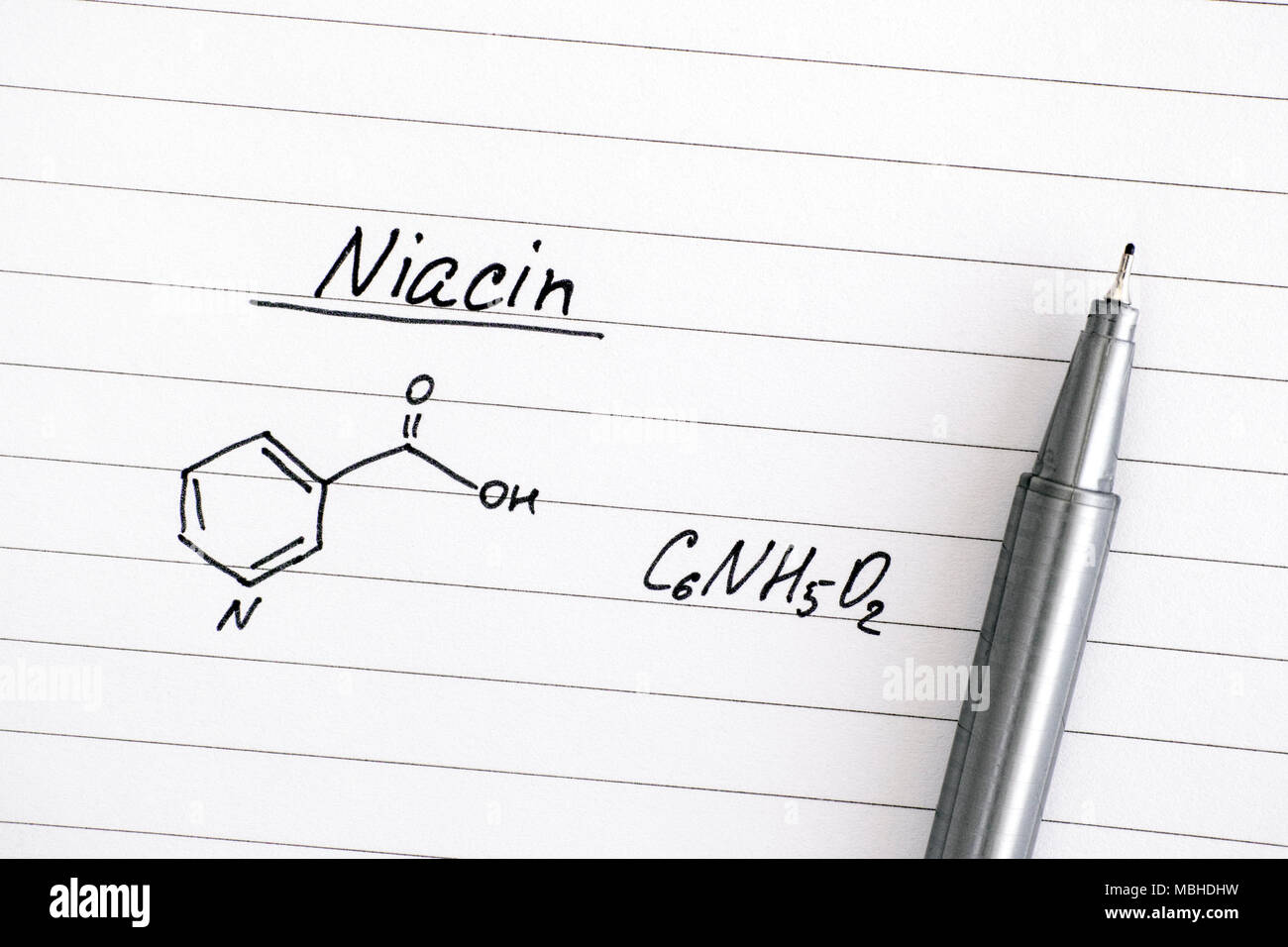 Chemical formula of Niacin on lined paper with black pen. Close-up ...