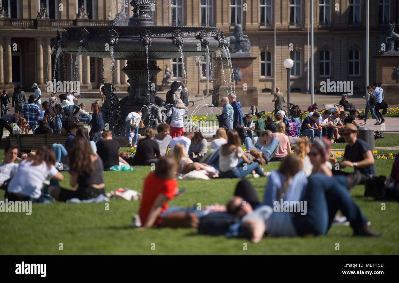11 April 2018, Stuttgart, Germany: People laying on the lawn at the ...