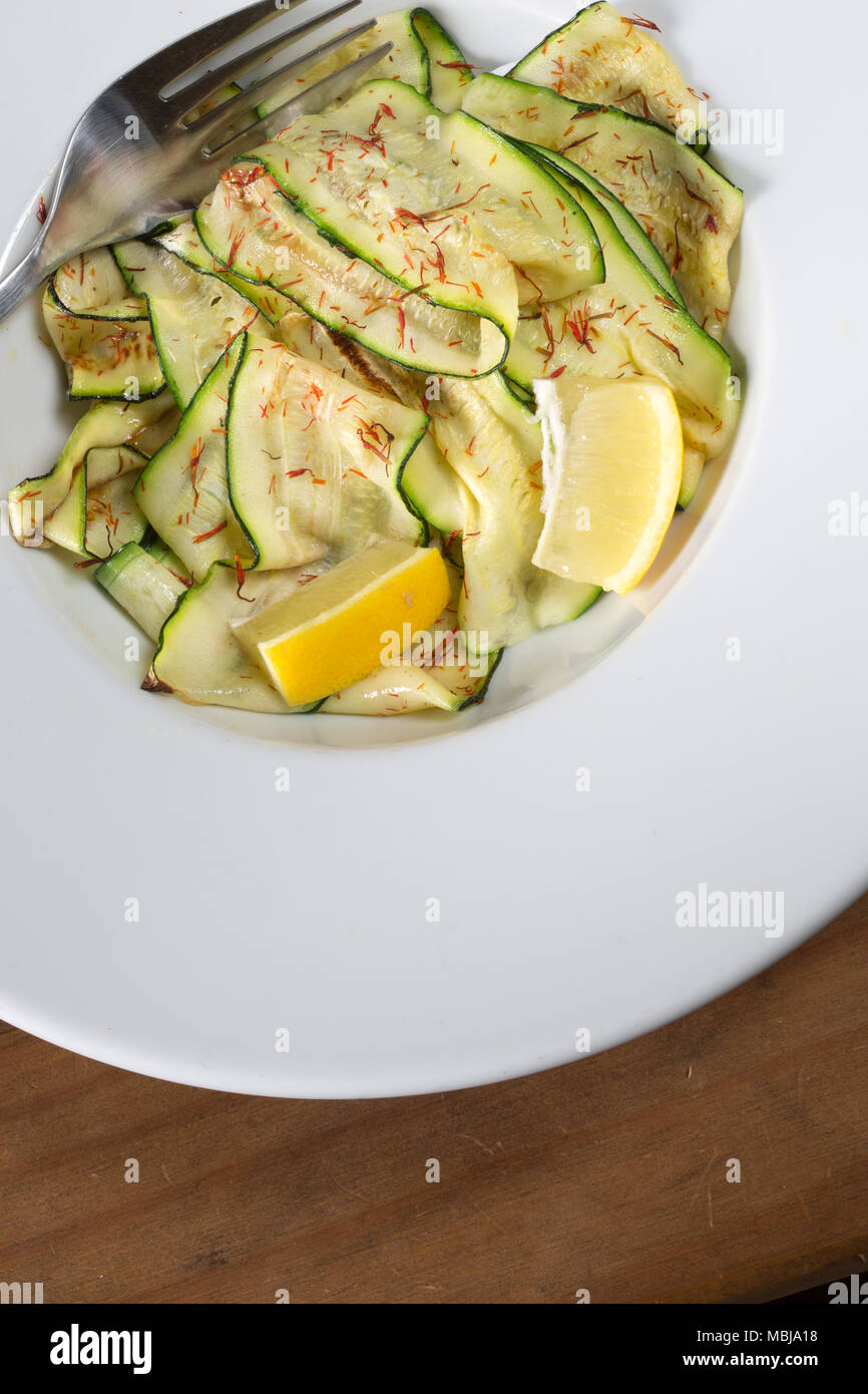 An accompaniment or side dish of ribboned Courgette sauteed with butter ...