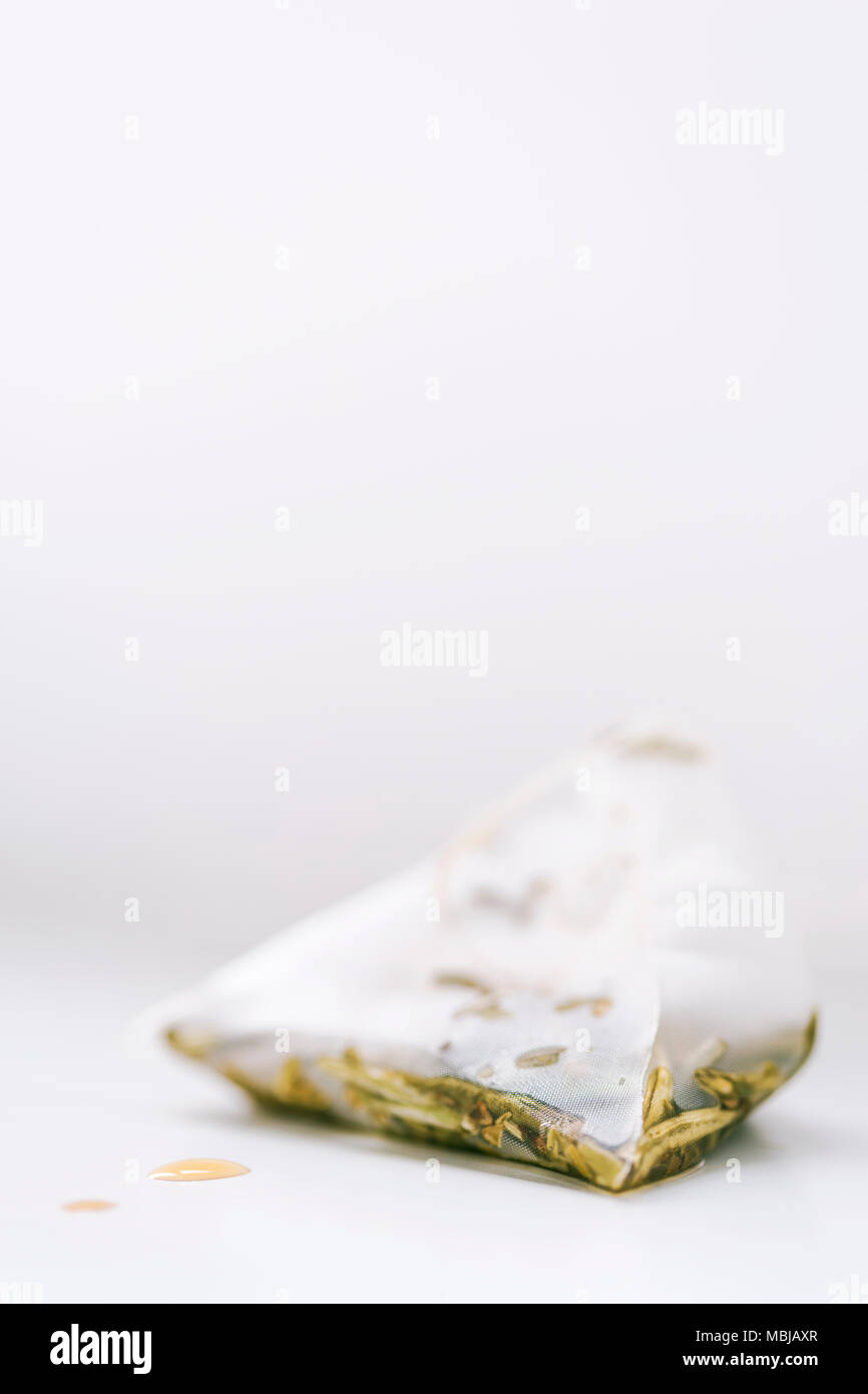 Triangle tea bags on white background Stock Photo - Alamy