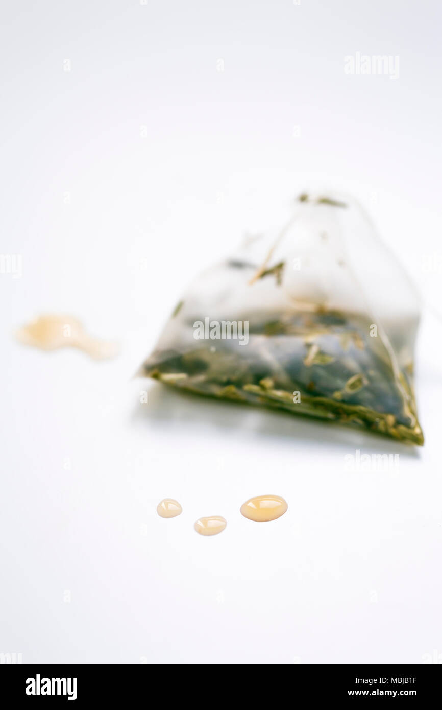 Triangle tea bags on white background Stock Photo - Alamy
