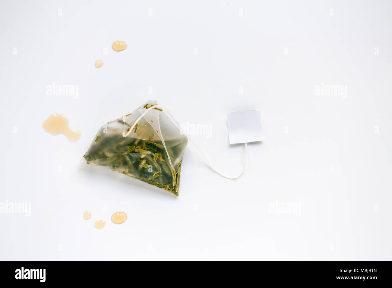 Triangle tea bags on white background Stock Photo - Alamy