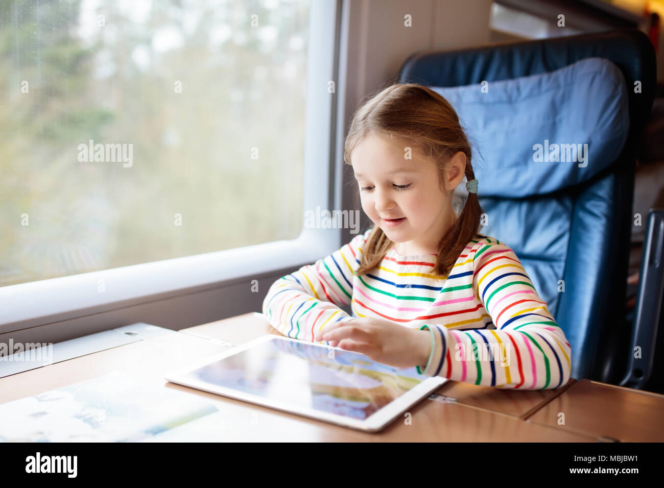 Child traveling by train. Little kid in a high speed express train on ...