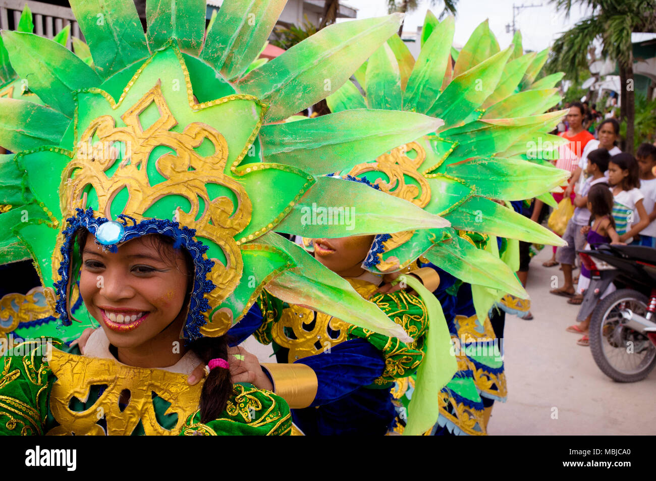 Boys in full costume smile as they march in a Holy Week parade on ...
