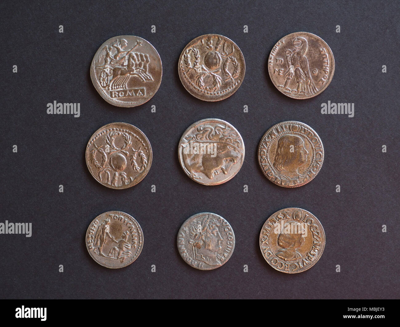 Ancient Roman and medieval coins over black background Stock Photo - Alamy