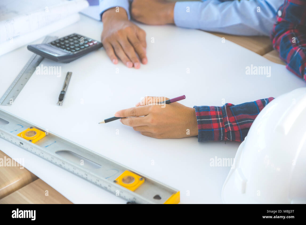 Close up on table architecture and engineering consult blueprint ...