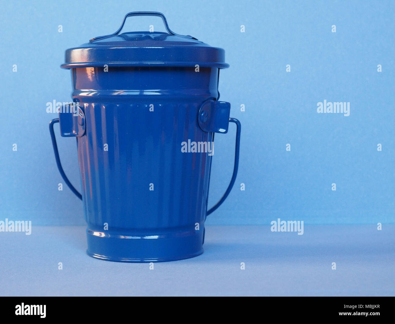 blue litter bin aka garbage or trash bin or waste bin with copy space ...