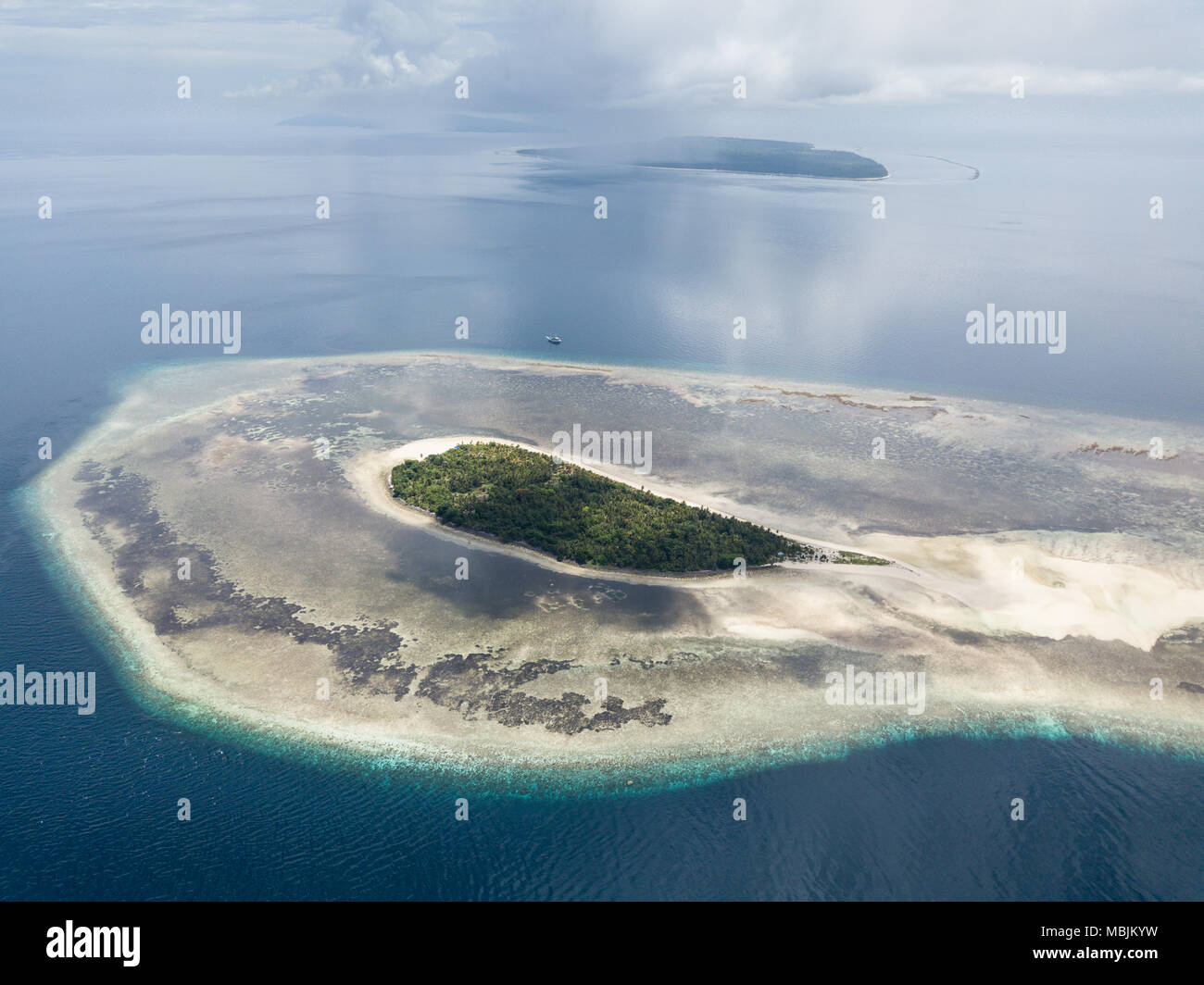 A beautiful coral reef rings a remote Indonesian island in the Banda ...