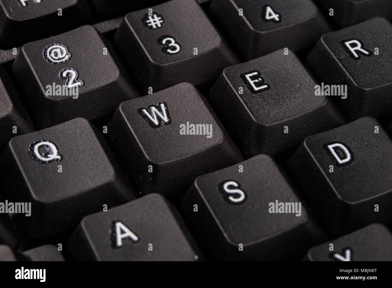 An enlarged computer keyboard. Black keyboard buttons for the computer ...