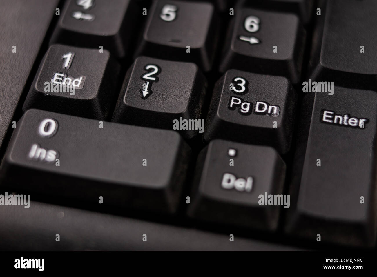An enlarged computer keyboard. Black keyboard buttons for the computer ...
