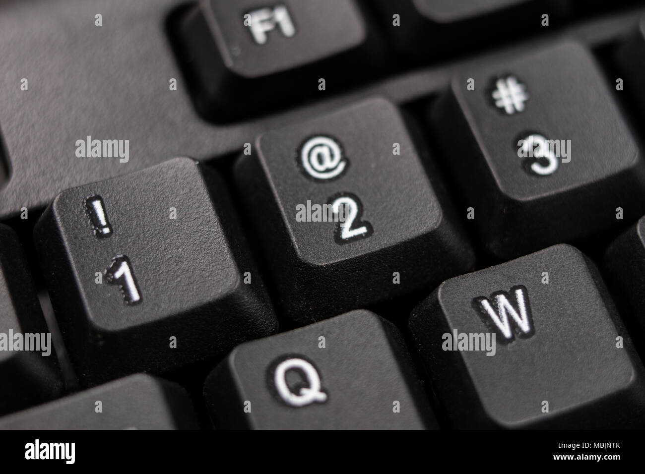 An enlarged computer keyboard. Black keyboard buttons for the computer ...