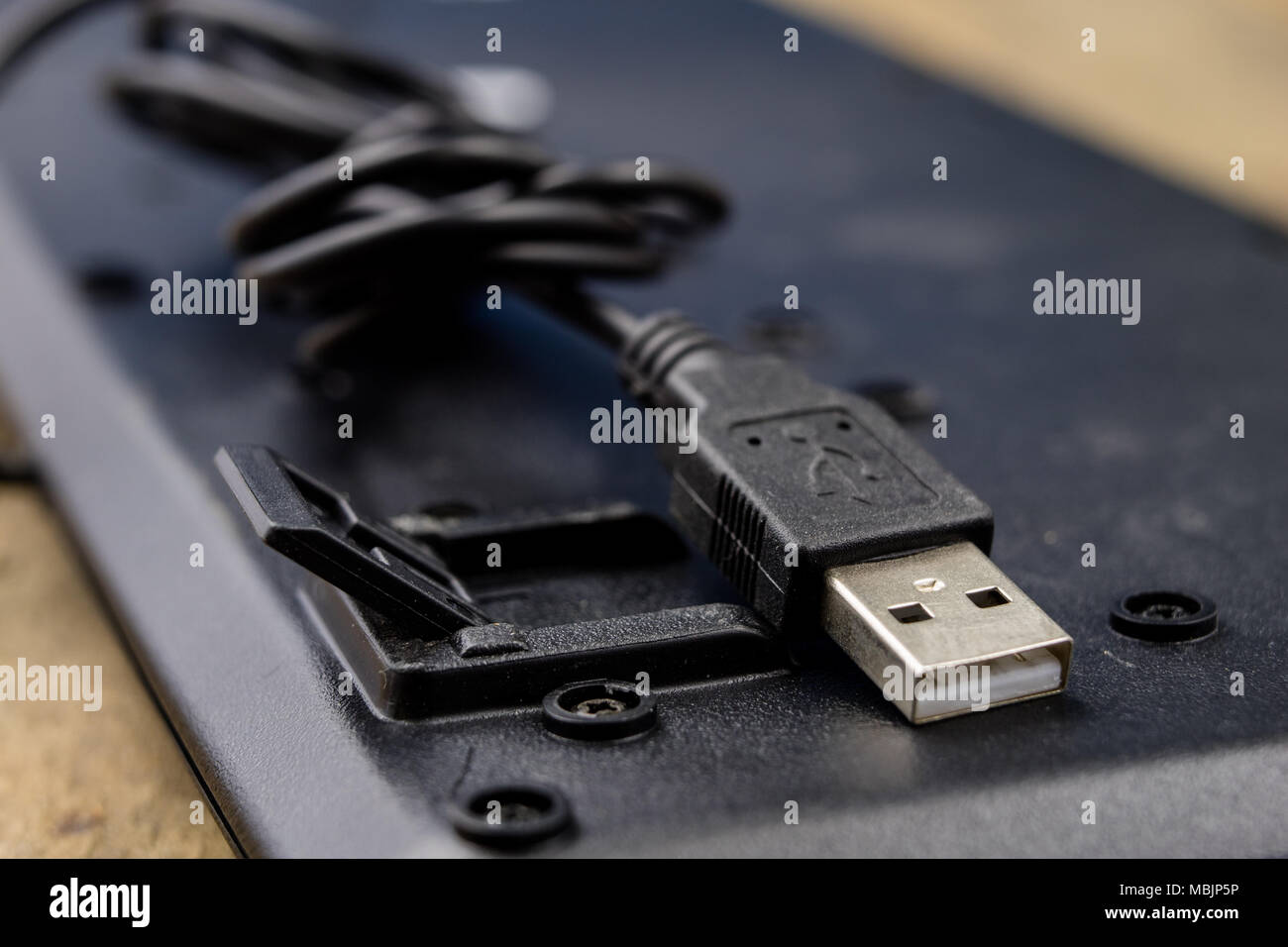 A black computer keyboard and an enlarged USB port. Computer ...