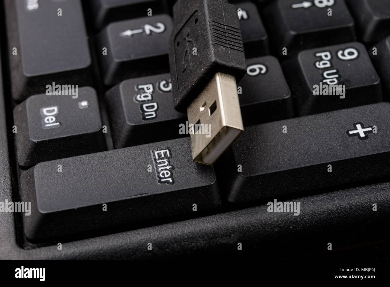 A black computer keyboard and an enlarged USB port. Computer ...