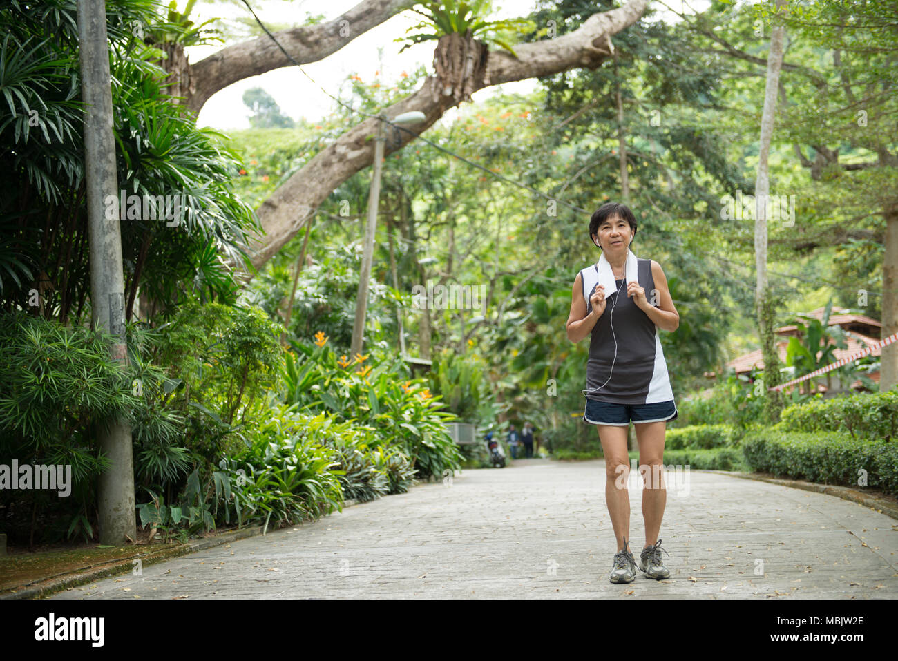 Asian woman jogging park hi-res stock photography and images - Alamy