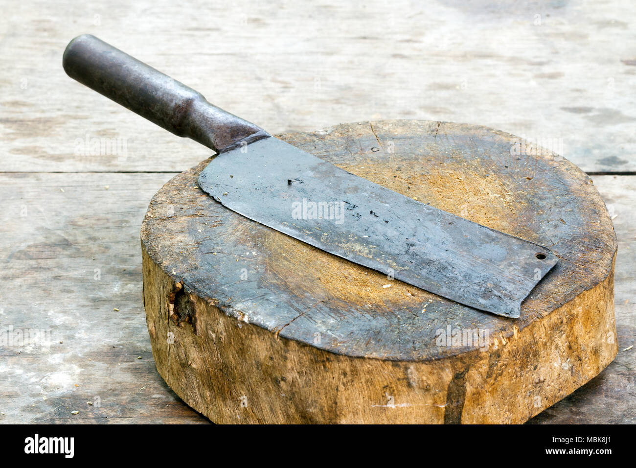 large old chef's knife on chopping block Stock Photo - Alamy