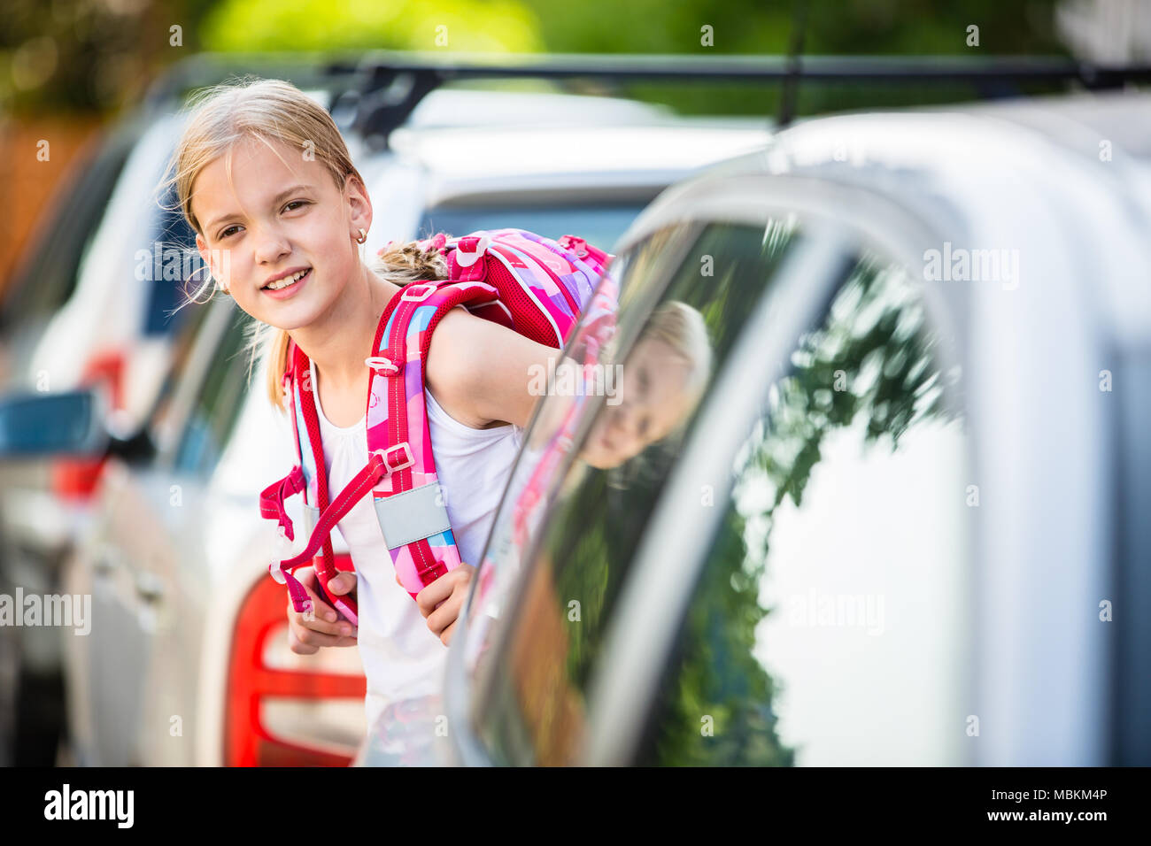 Cute little girl going home from school, looking well before crossing ...