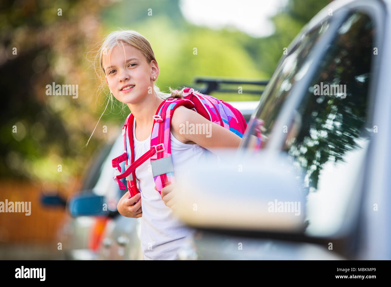 Cute little girl going home from school, looking well before crossing ...