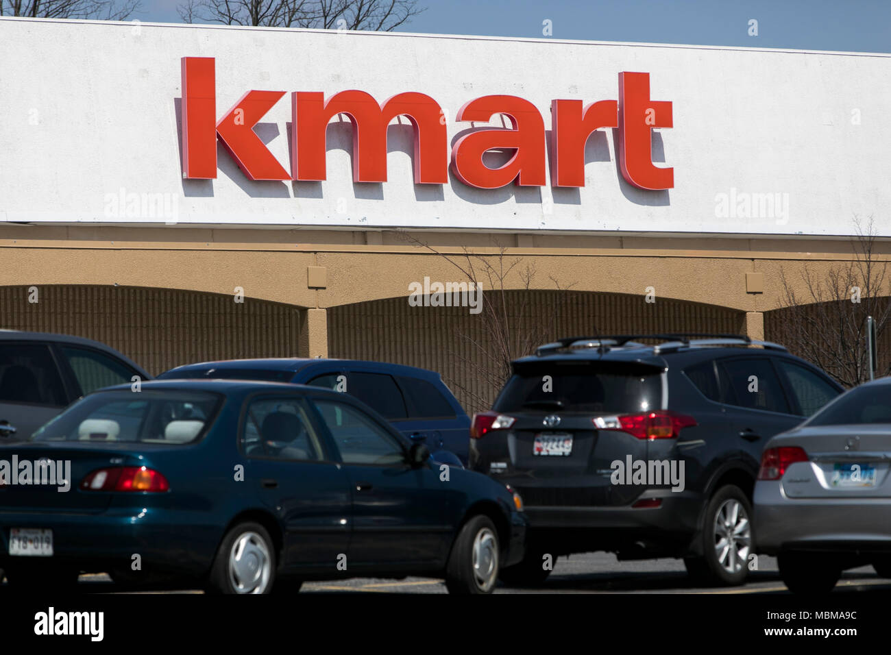 A logo sign outside of a Kmart retail store location in Silver Spring ...