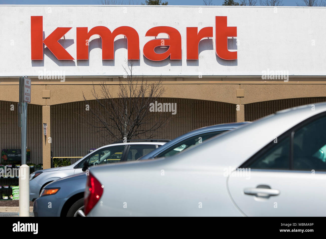 A logo sign outside of a Kmart retail store location in Silver Spring ...