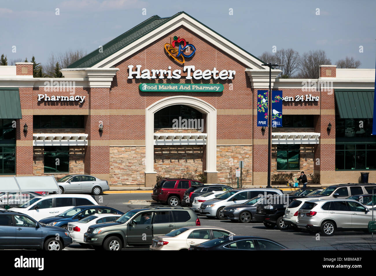 A logo sign outside of a Harris Teeter grocery retail store location in ...
