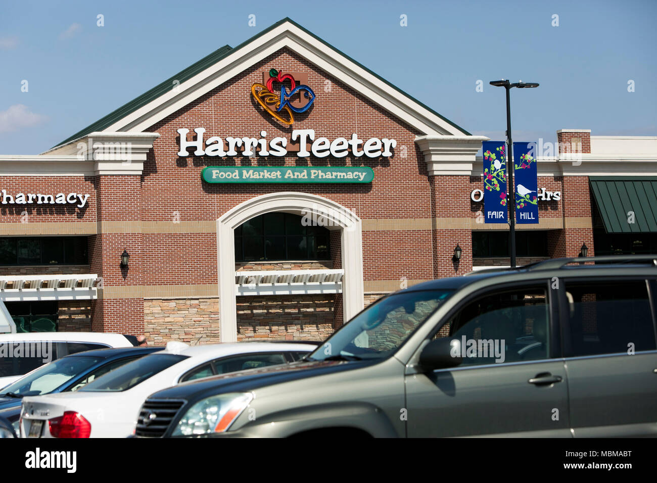 A logo sign outside of a Harris Teeter grocery retail store location in ...