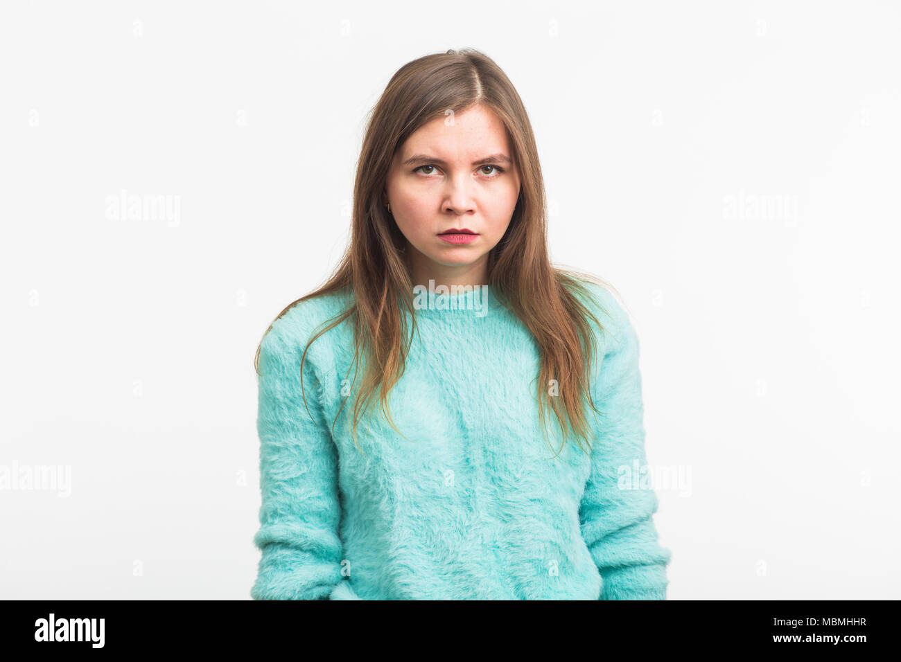 Portrait of angry woman standing on white background Stock Photo - Alamy