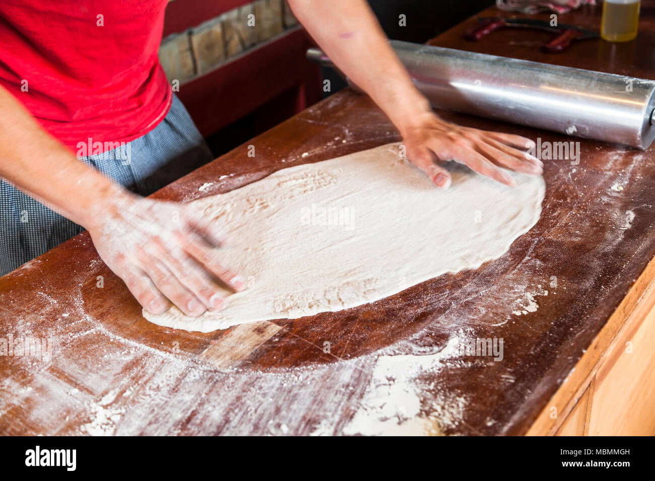 Chef preparing pizza, spreading the mass Stock Photo - Alamy