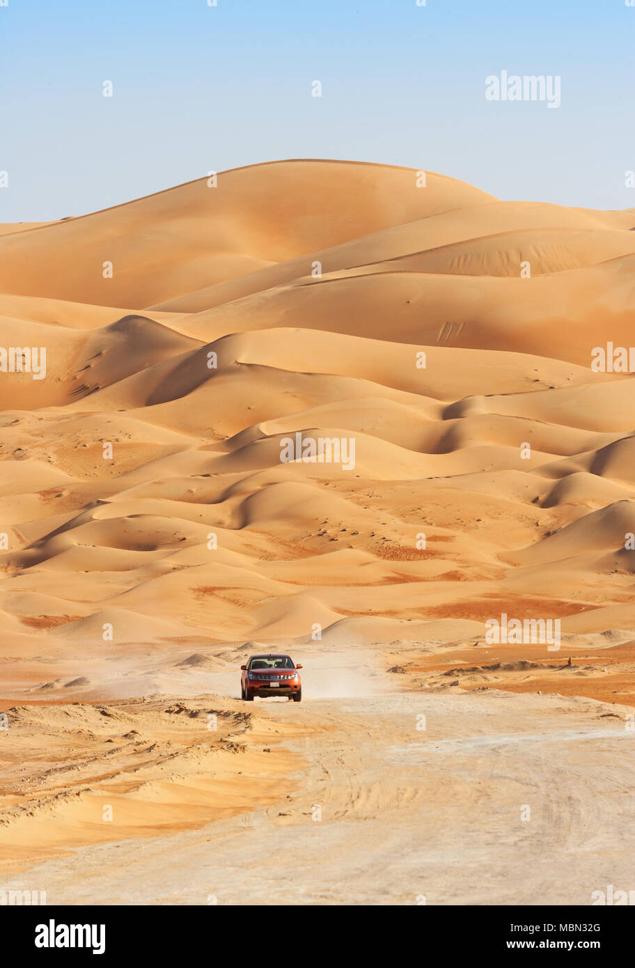 A vehicle driving through sand dunes in the Rub al Khali or Empty ...