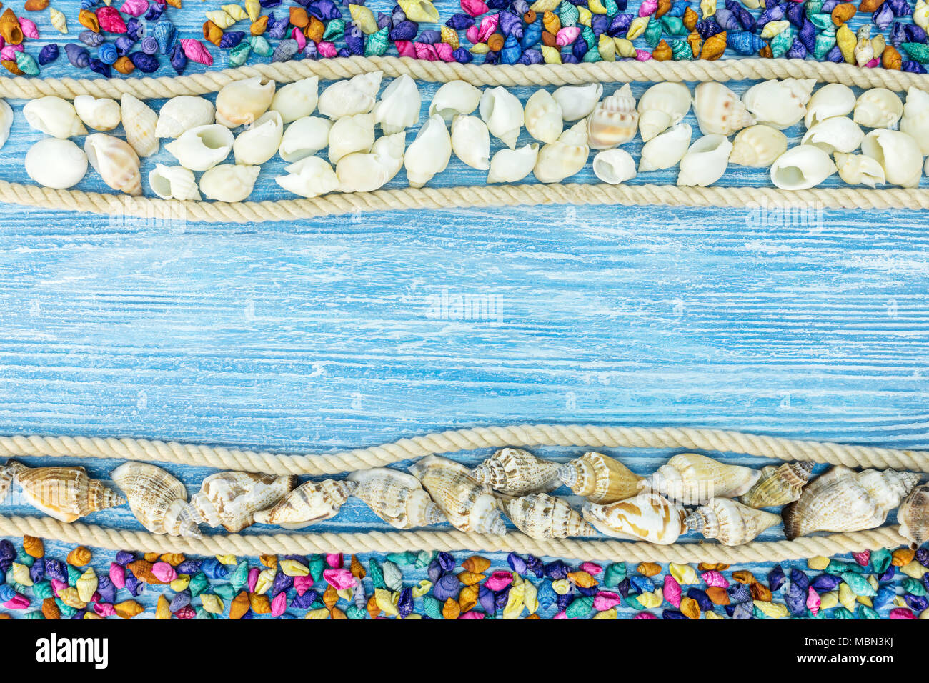blue wooden rustic boards with seashells and rope. summer vacation ...