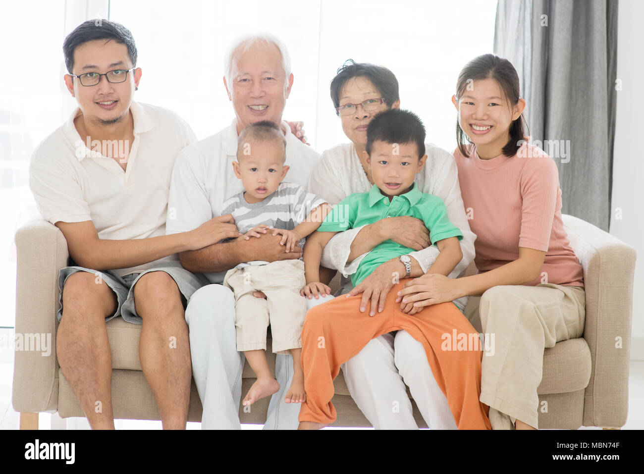Portrait of happy Asian family at home, multi generations indoor ...