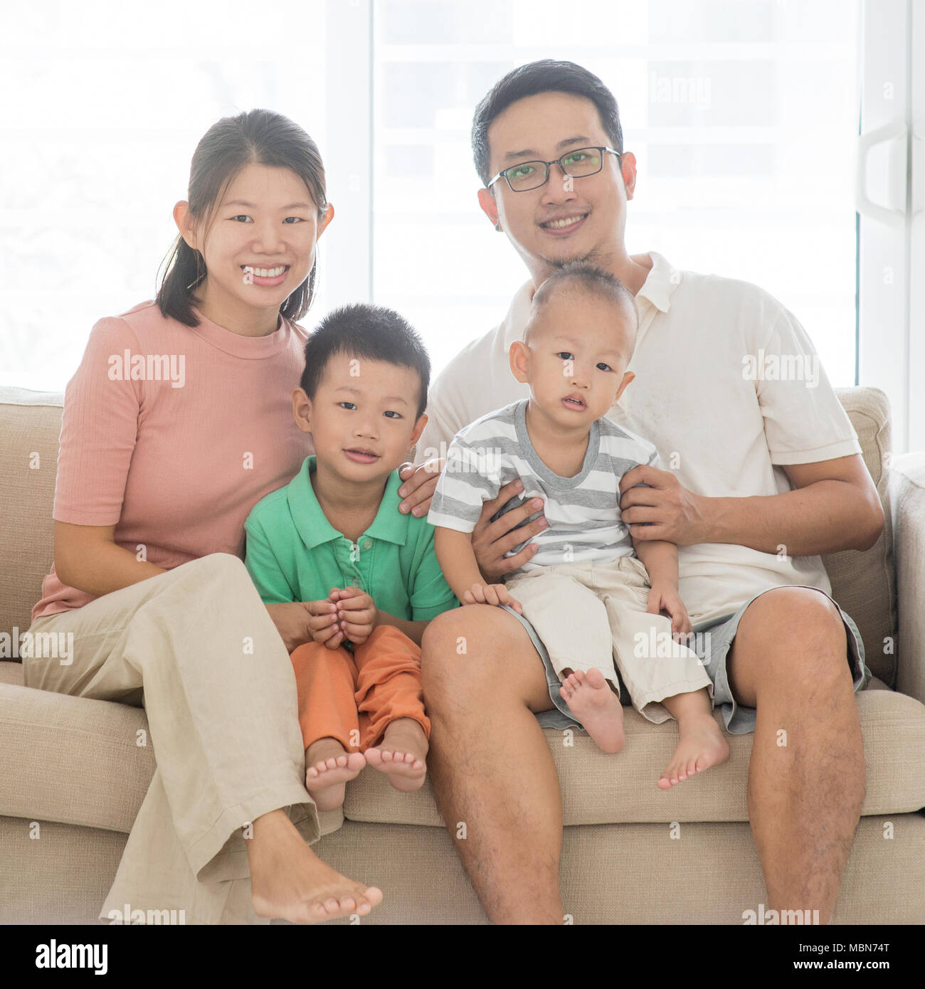Happy Asian family portrait at home, parents and children indoor ...