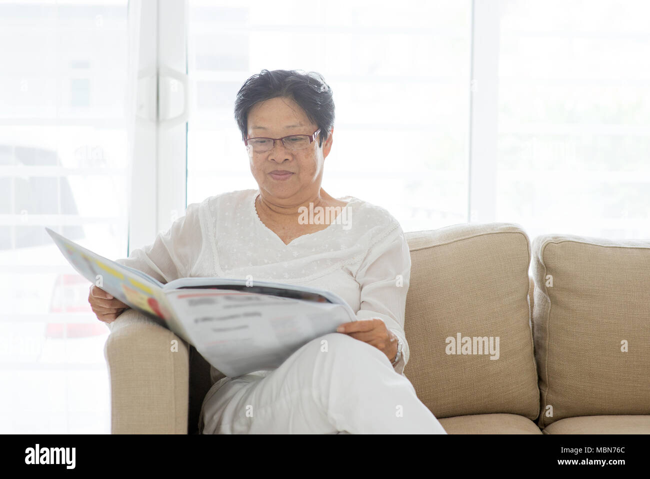 Asian elderly people reading newspaper at home, 60s old senior woman ...
