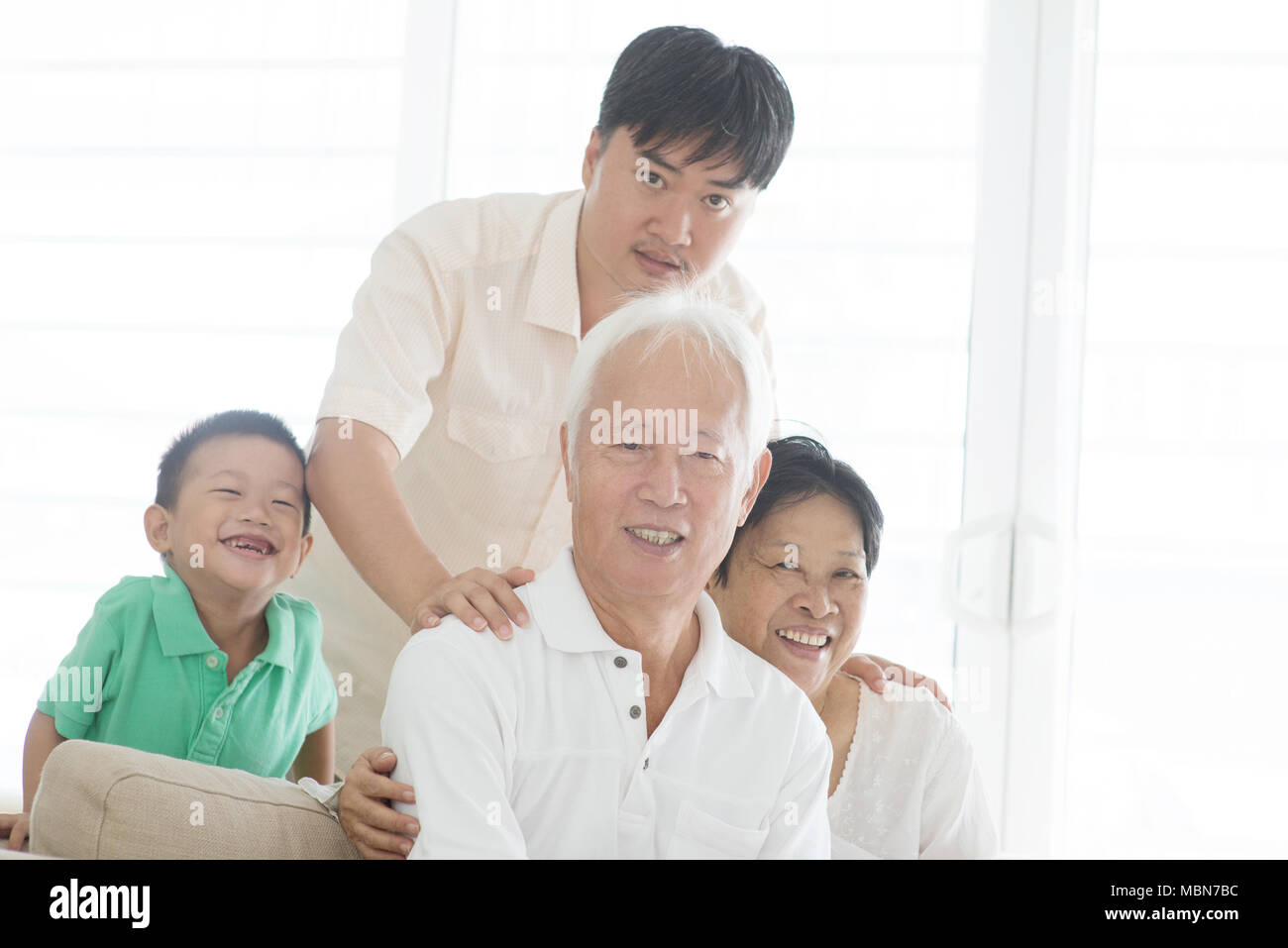 Portrait of happy Asian family at home, multi generations people indoor ...
