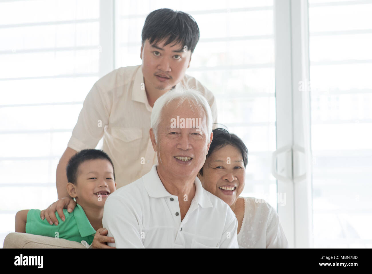 Happy Asian family at home, portrait of multi generations people indoor ...