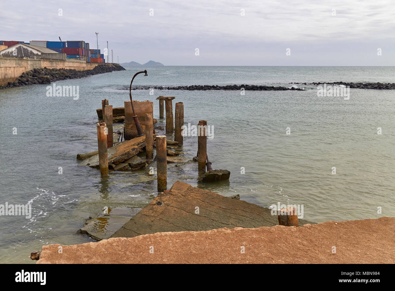 An old abandoned and collapsed Fishing Pier alongside the Sea wall of ...