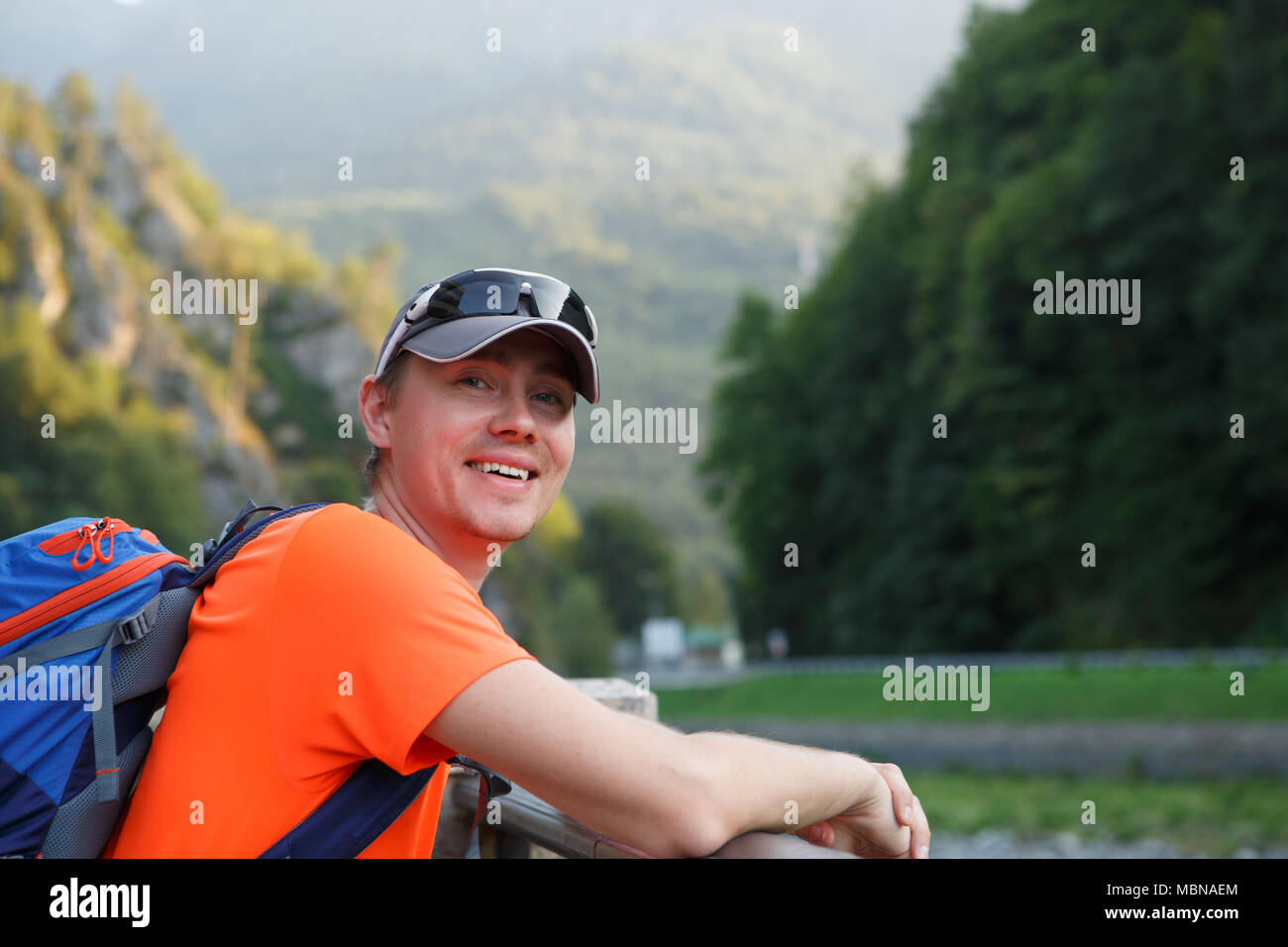 Smiling man against background of mountain landscape Stock Photo - Alamy