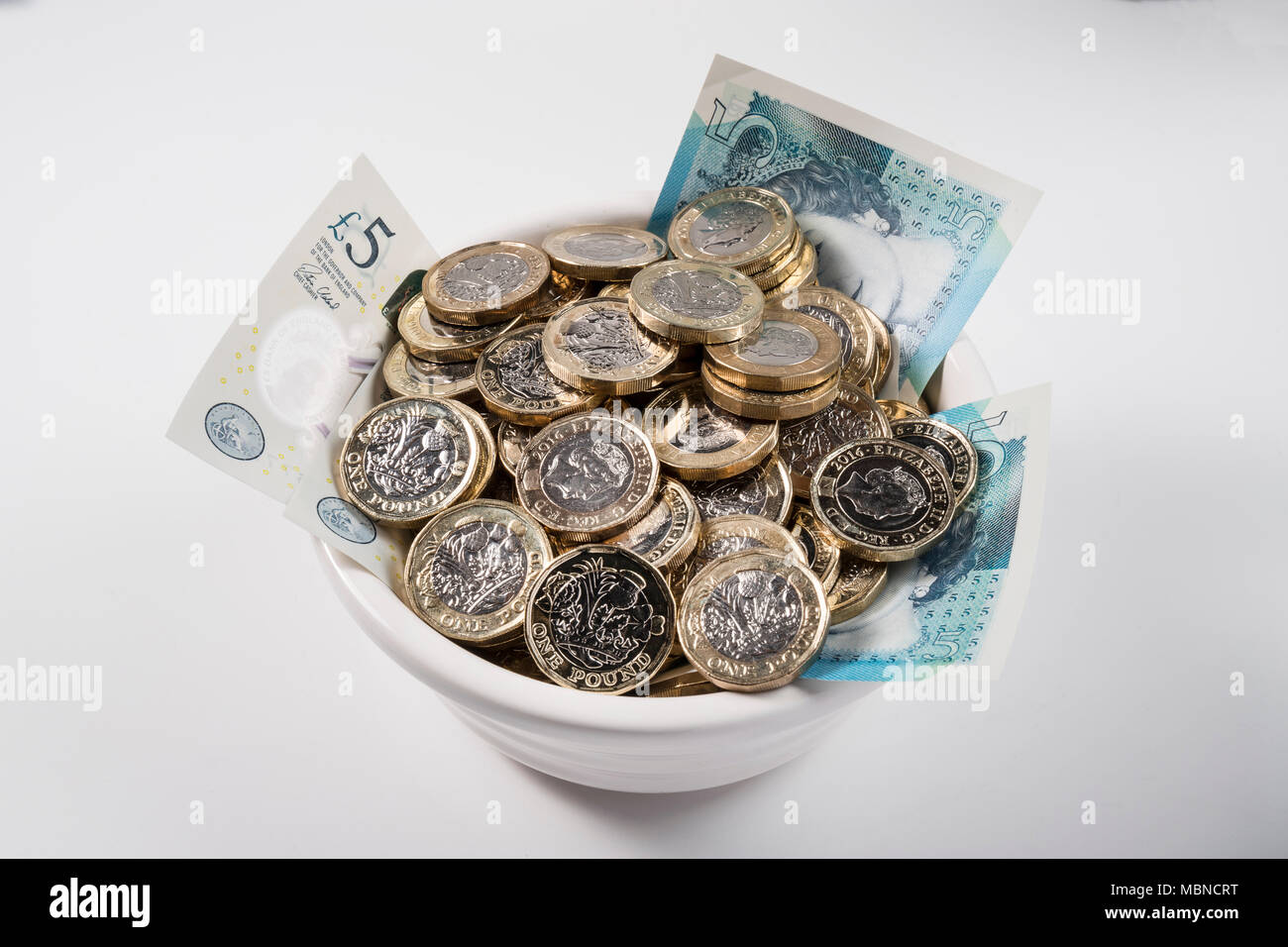 Coins in a bowl hi-res stock photography and images - Alamy