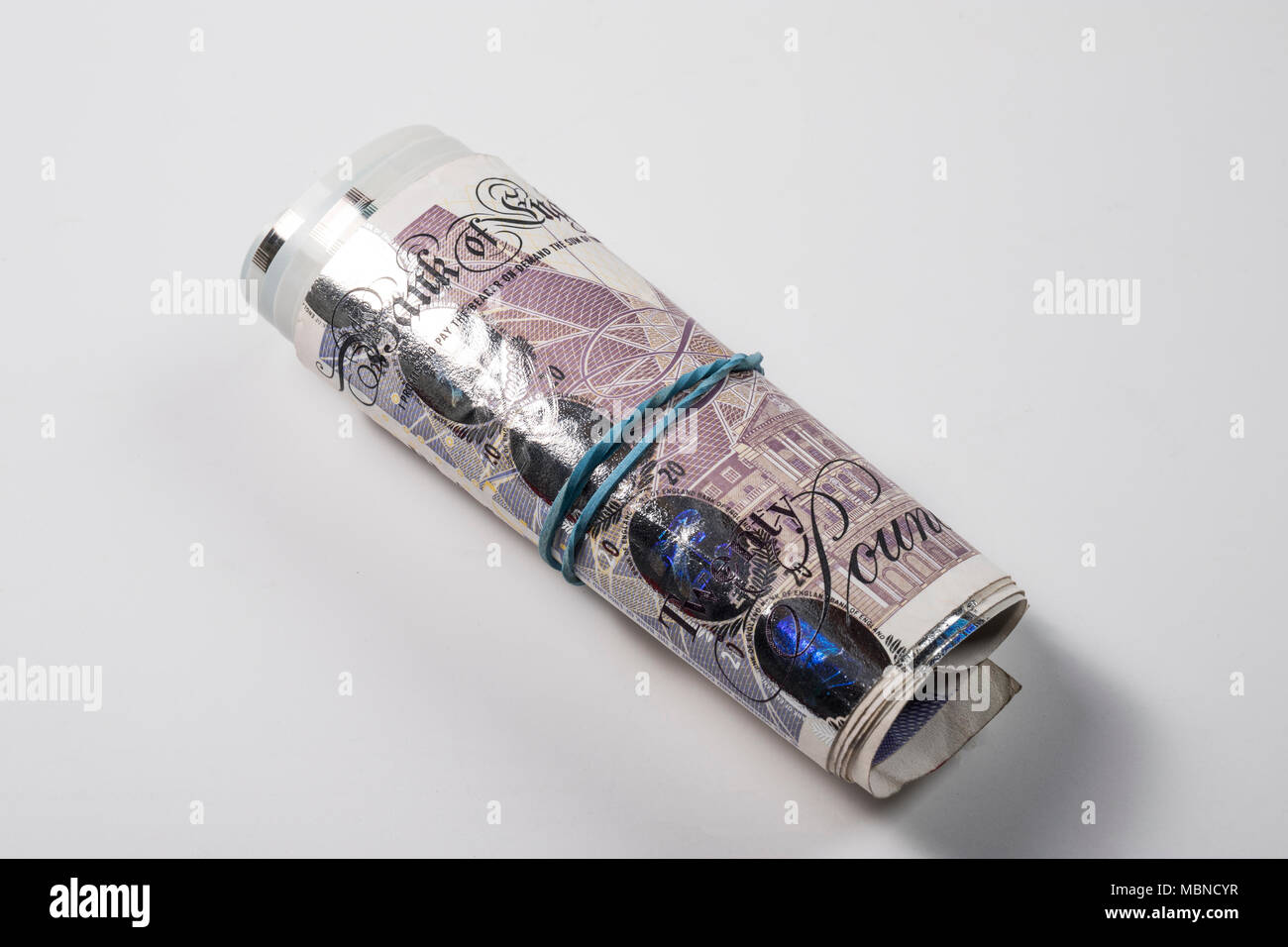 A roll of UK £20.00 notes Stock Photo - Alamy