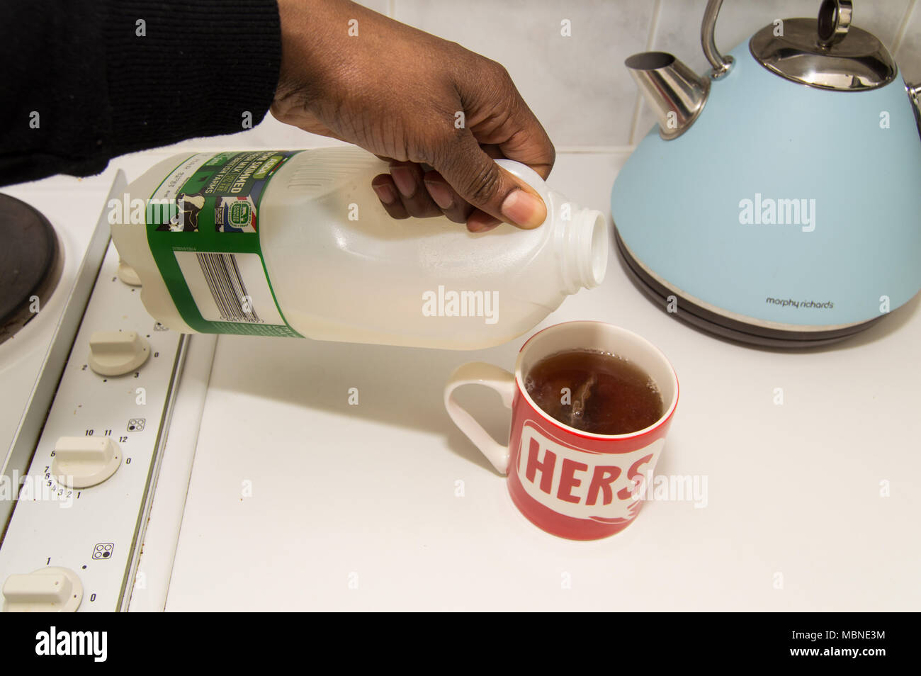 First person image of a black woman making a cup of tea with a blue ...