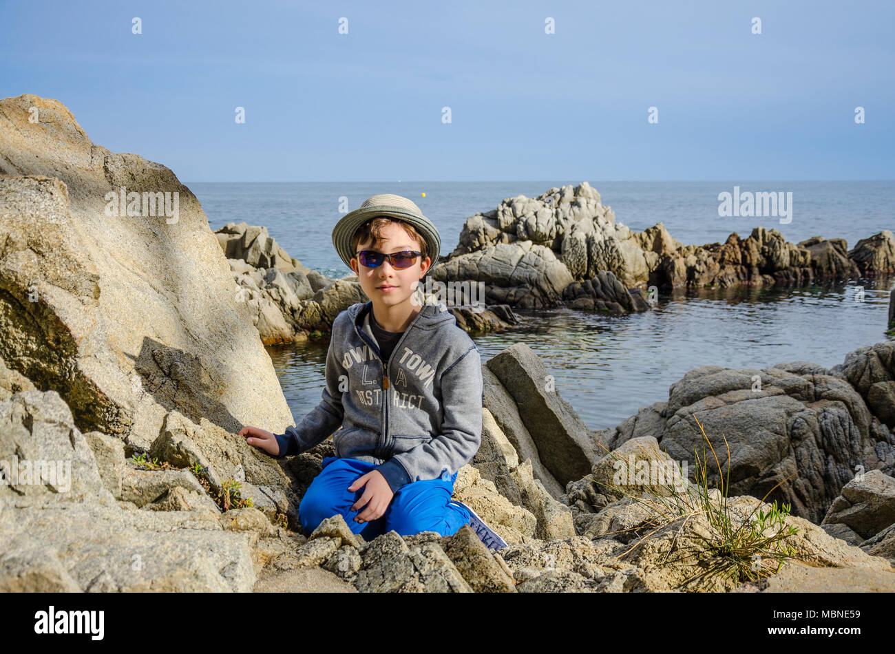 Child on top of rocks hi-res stock photography and images - Alamy