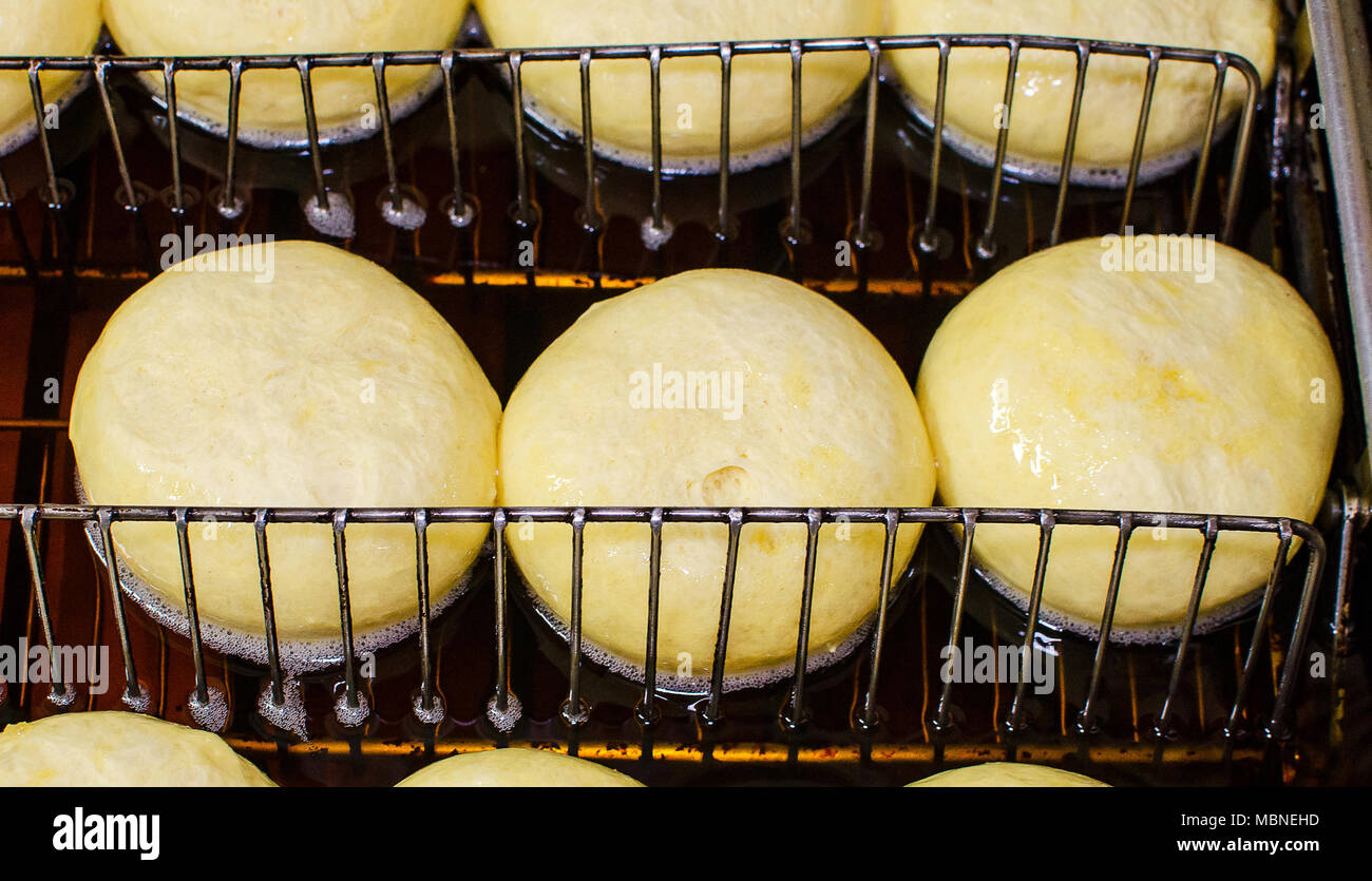 Preparation of donuts. Roasting in boiling oil. Cookng, fried Stock ...