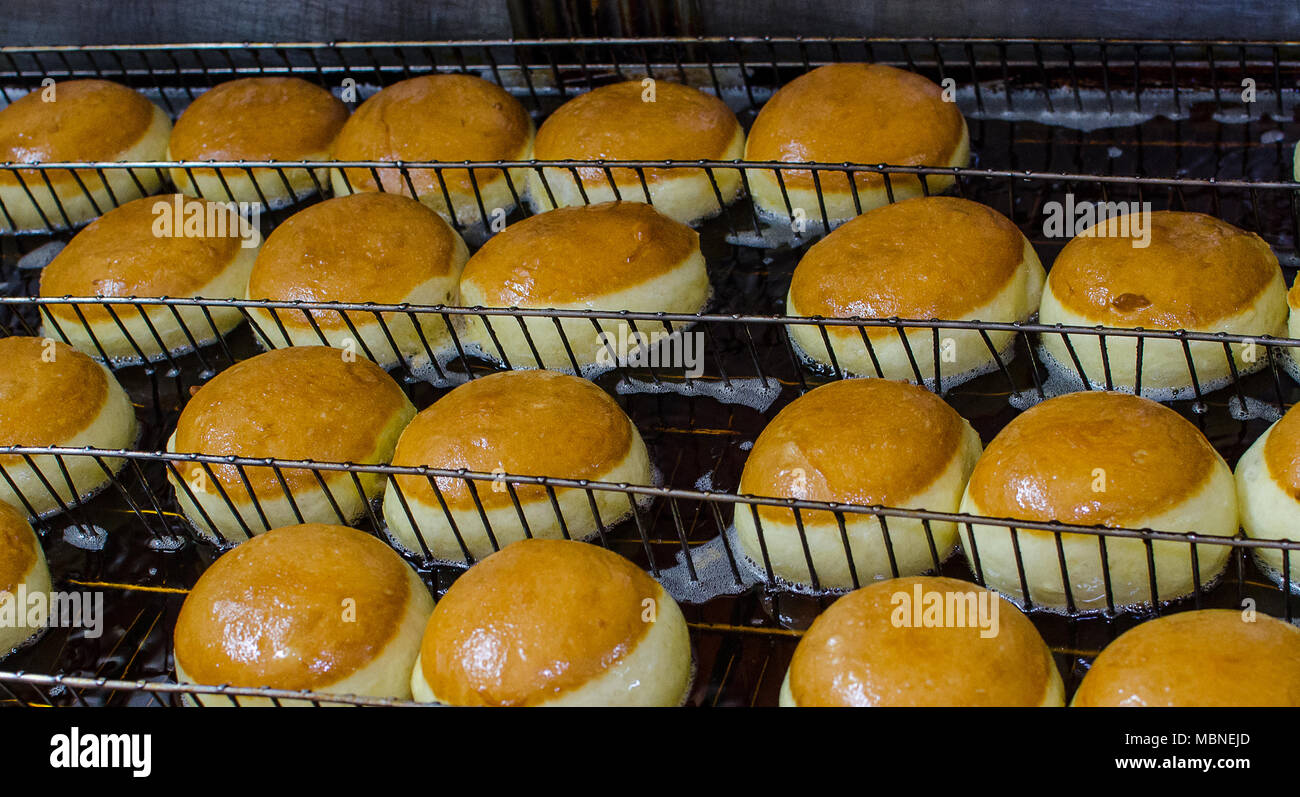 Preparation of donuts. Roasting in boiling oil. Cookng, fried Stock ...