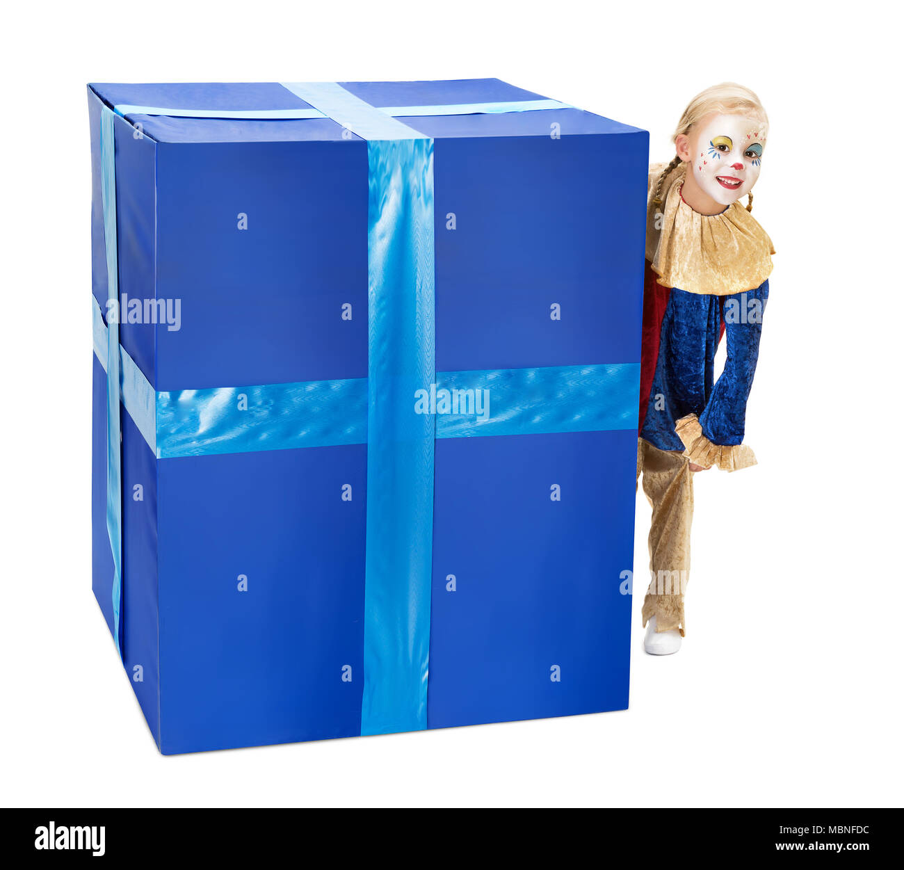 Adorable little girl playing peek-a-boo behind a big blue surprise box ...