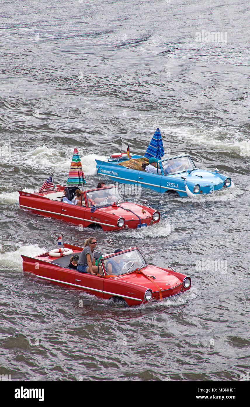 Three Amphic cars, a german amphibious vehicle driving on Moselle river ...