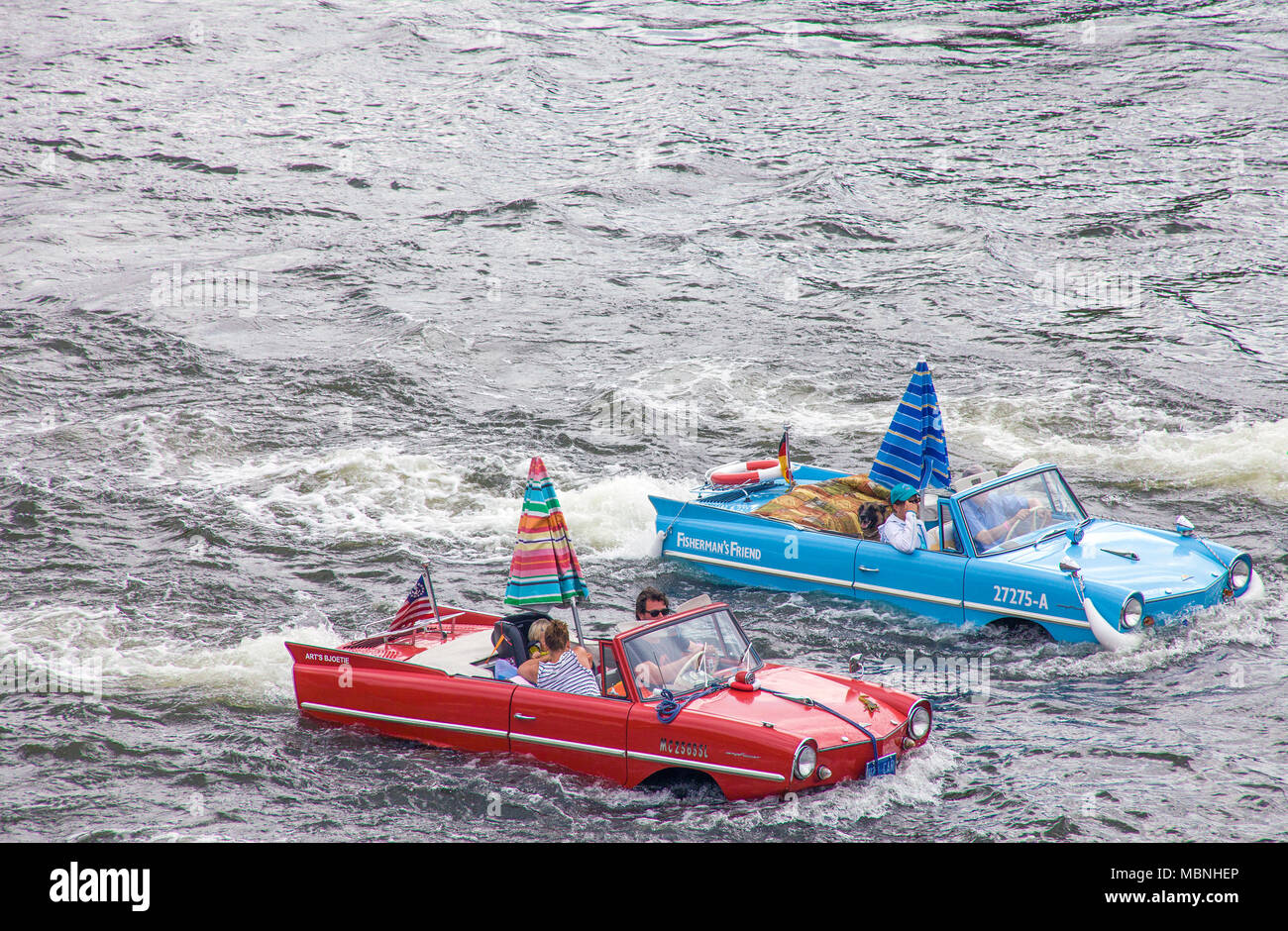 Two Amphic cars, a german amphibious vehicle driving on Moselle river ...