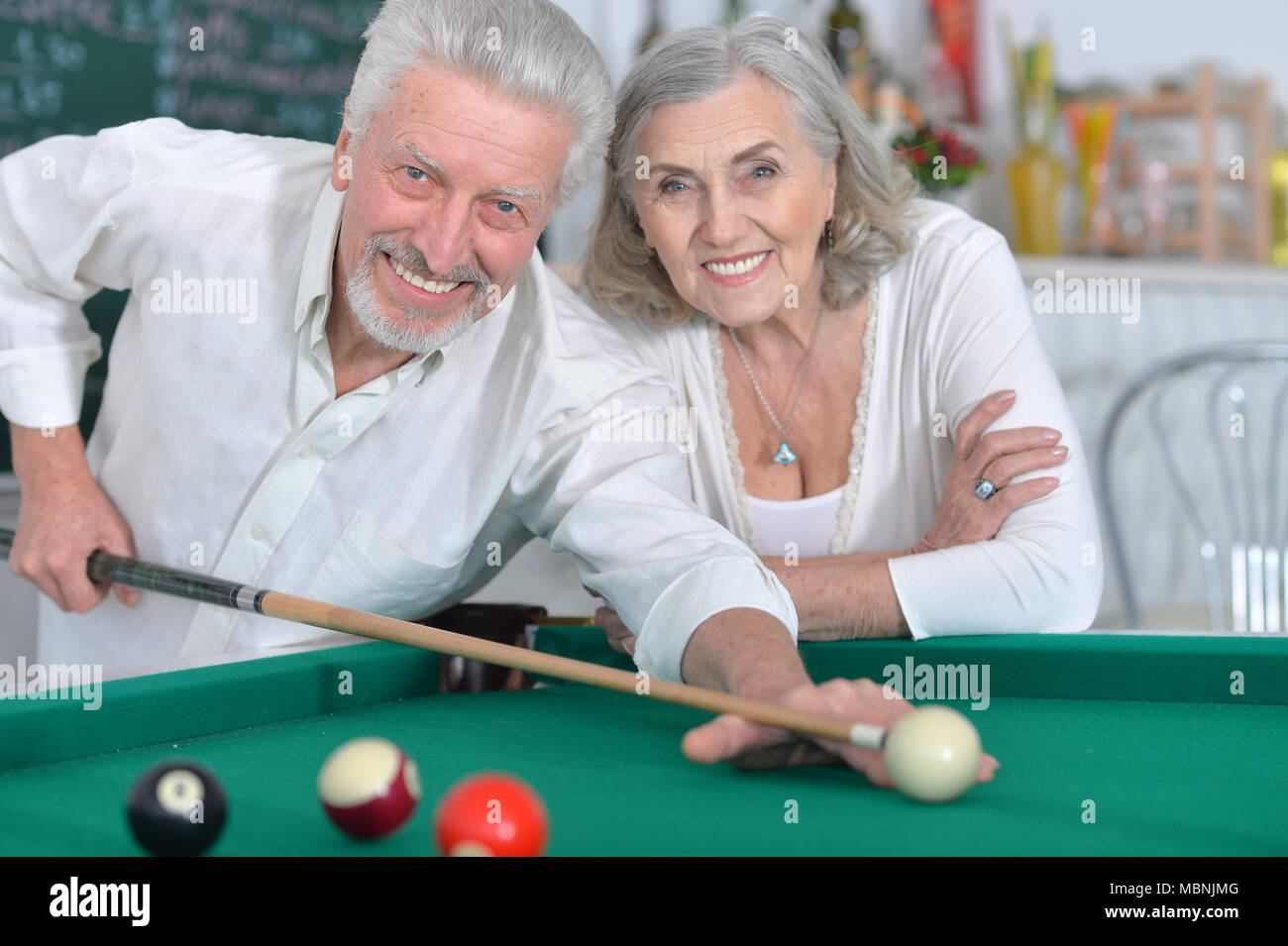 Mature woman playing billiard hi-res stock photography and images - Alamy