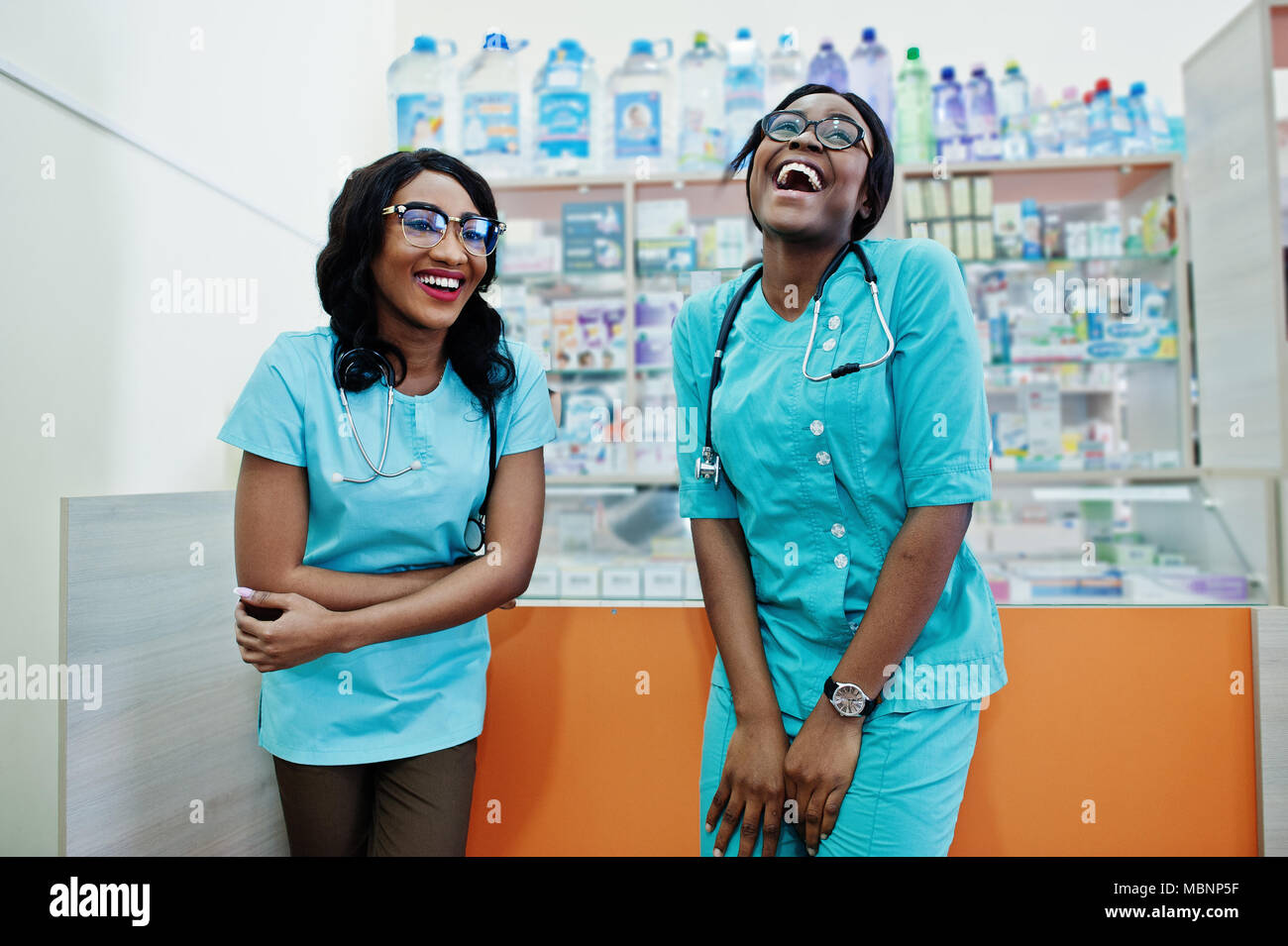 Two african american pharmacist working in drugstore at hospital ...